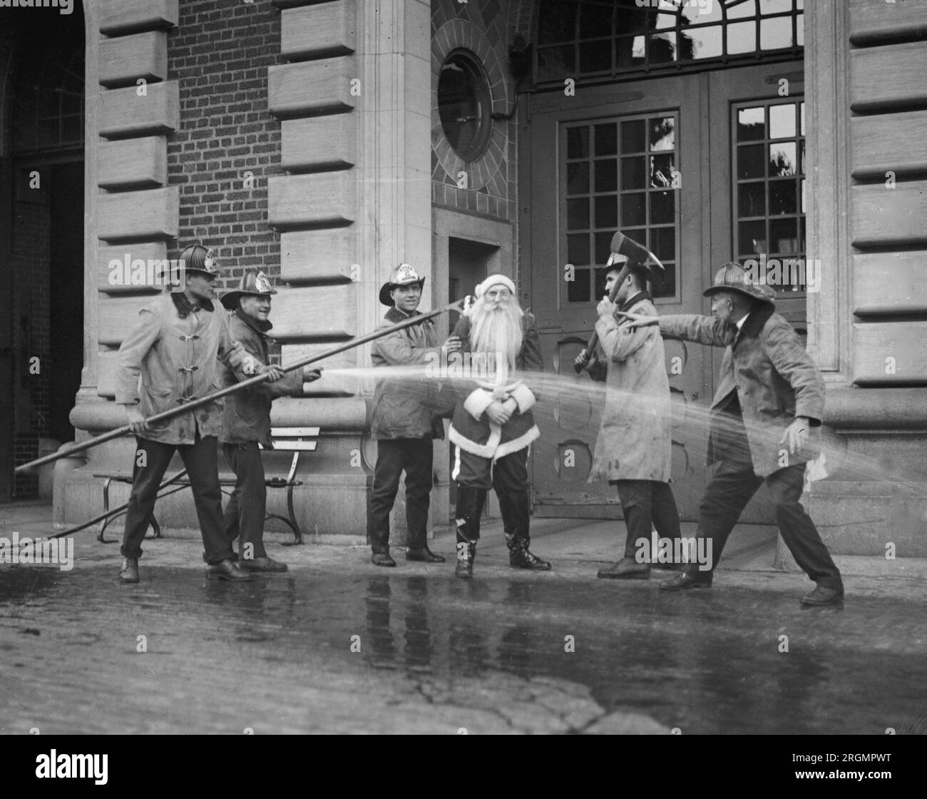 Santa Claus visiting a fire department ca. 1921 Stock Photo - Alamy