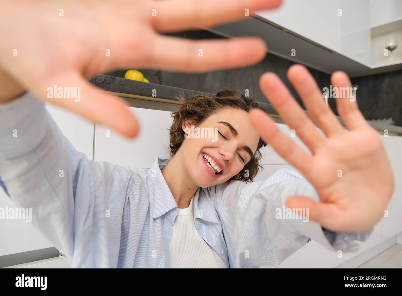 Lifestyle and people concept. Young happy woman hides from camera ...