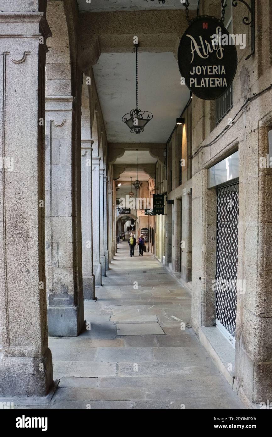 Historic city centre shopping arcade covered walkway with stone columns ...