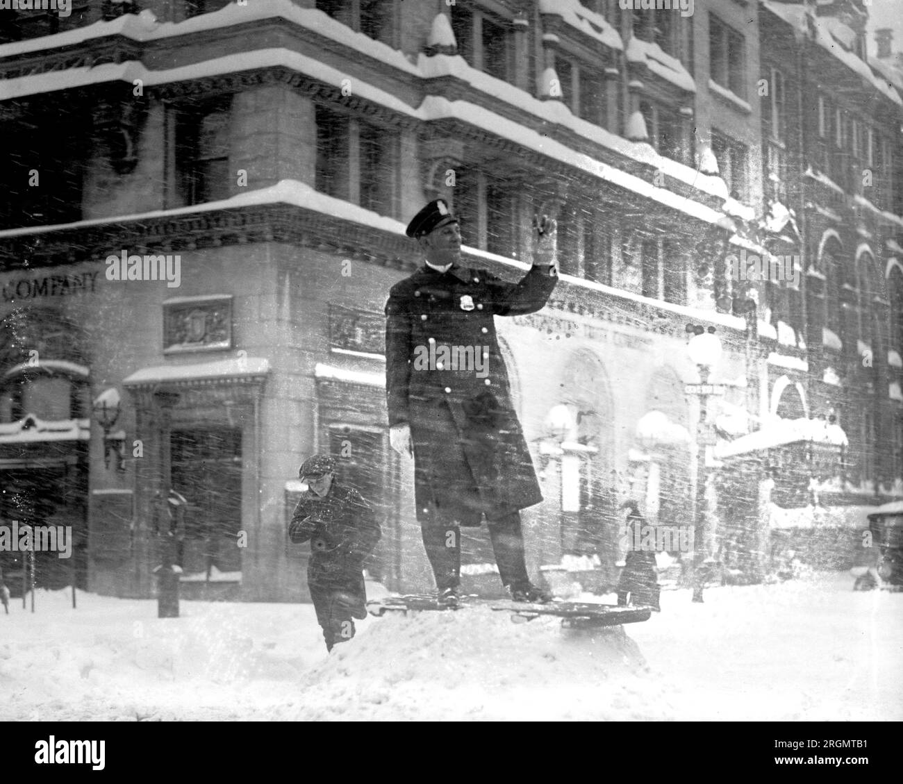 A police officer directing traffic during a blizzard ca. 1922 Stock ...
