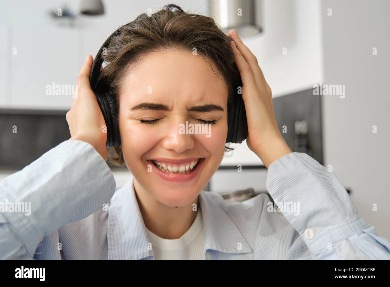 Close up portrait of woman, getting emotional from music, listening to ...