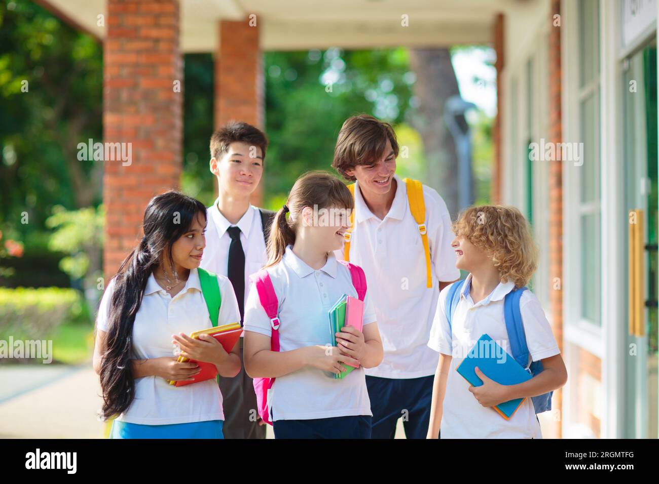 Kids go back to school. Interracial group of children of mixed age on ...