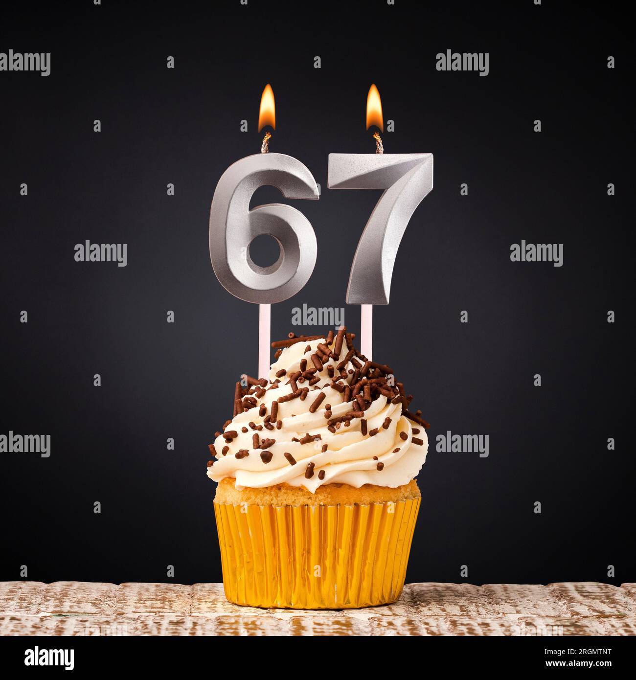 Birthday candle number 67 - Anniversary cupcake on black background ...