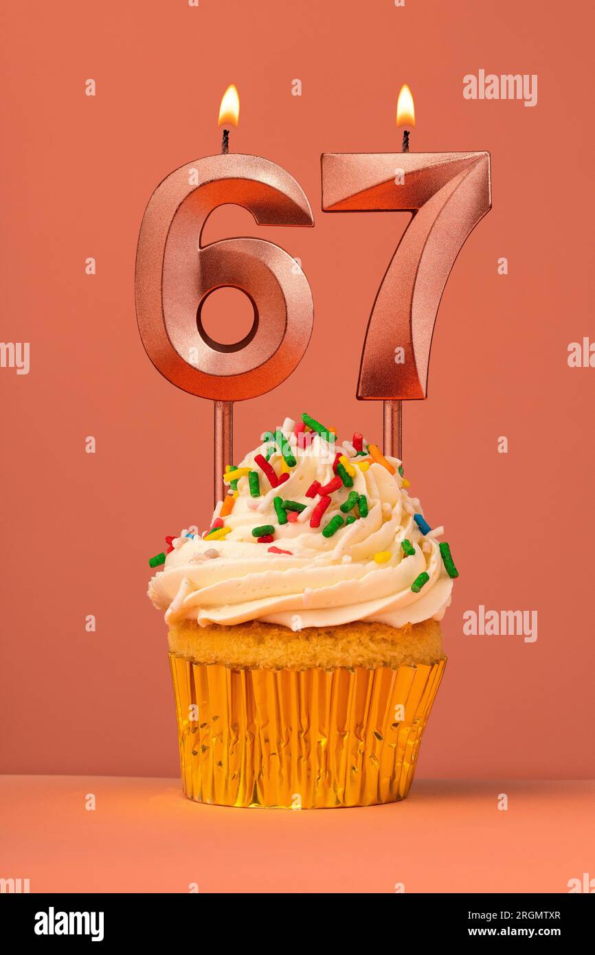 Birthday cake with candle number 67 - Coral fusion background Stock ...