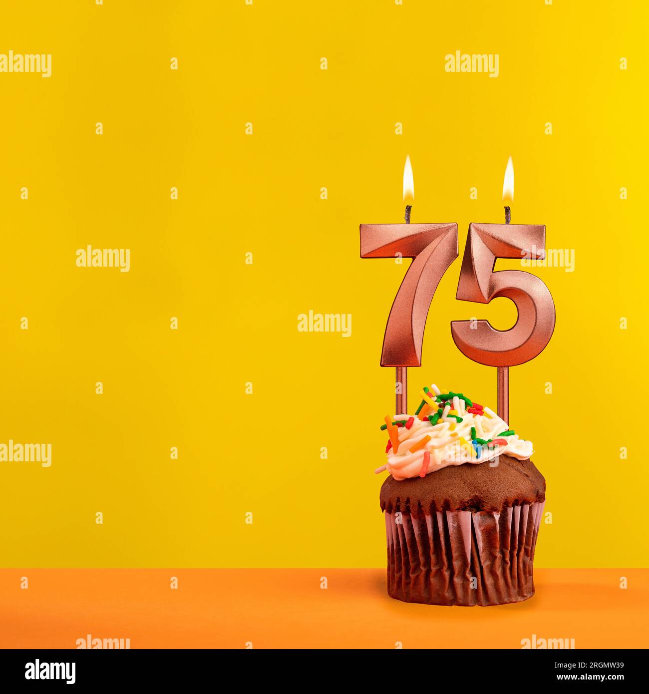 Candle with flame number 75 - Birthday card on yellow background Stock ...