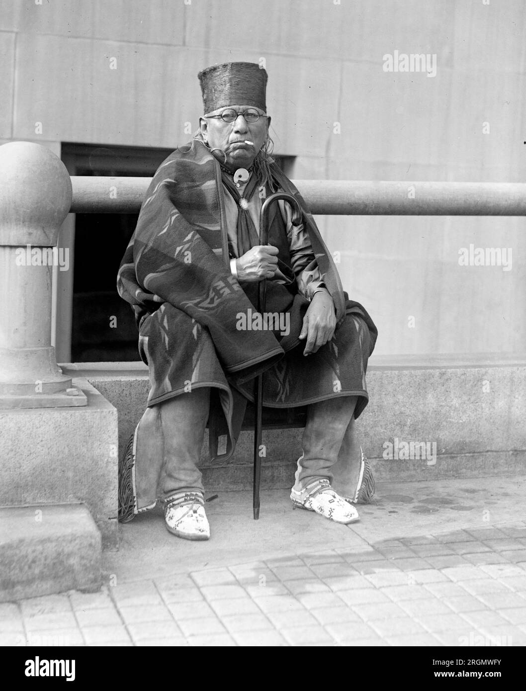 Chief Bacon Rind sitting outdoors, smoking a cigarette ca. 1923 Stock ...