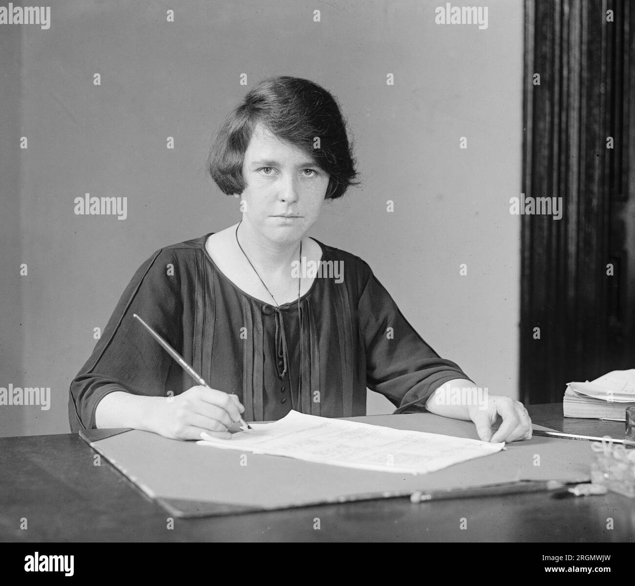Miss Ann Pollitzer sitting at a desk ca. 1923 Stock Photo - Alamy