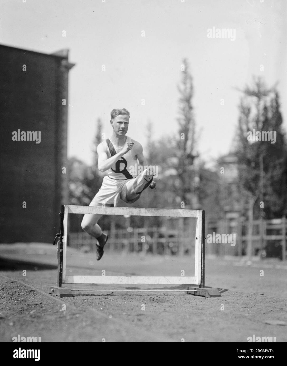 Track and field athelte James Morris jumping a hurdle ca. 1923 Stock ...