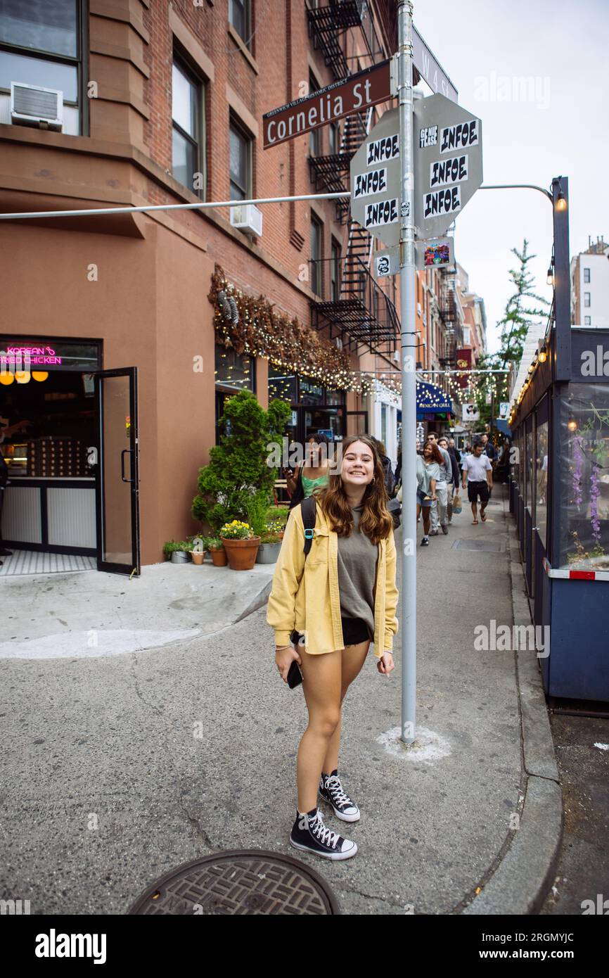 Teen girl fan posing with Cornelia Street sign, West Village, honoring ...