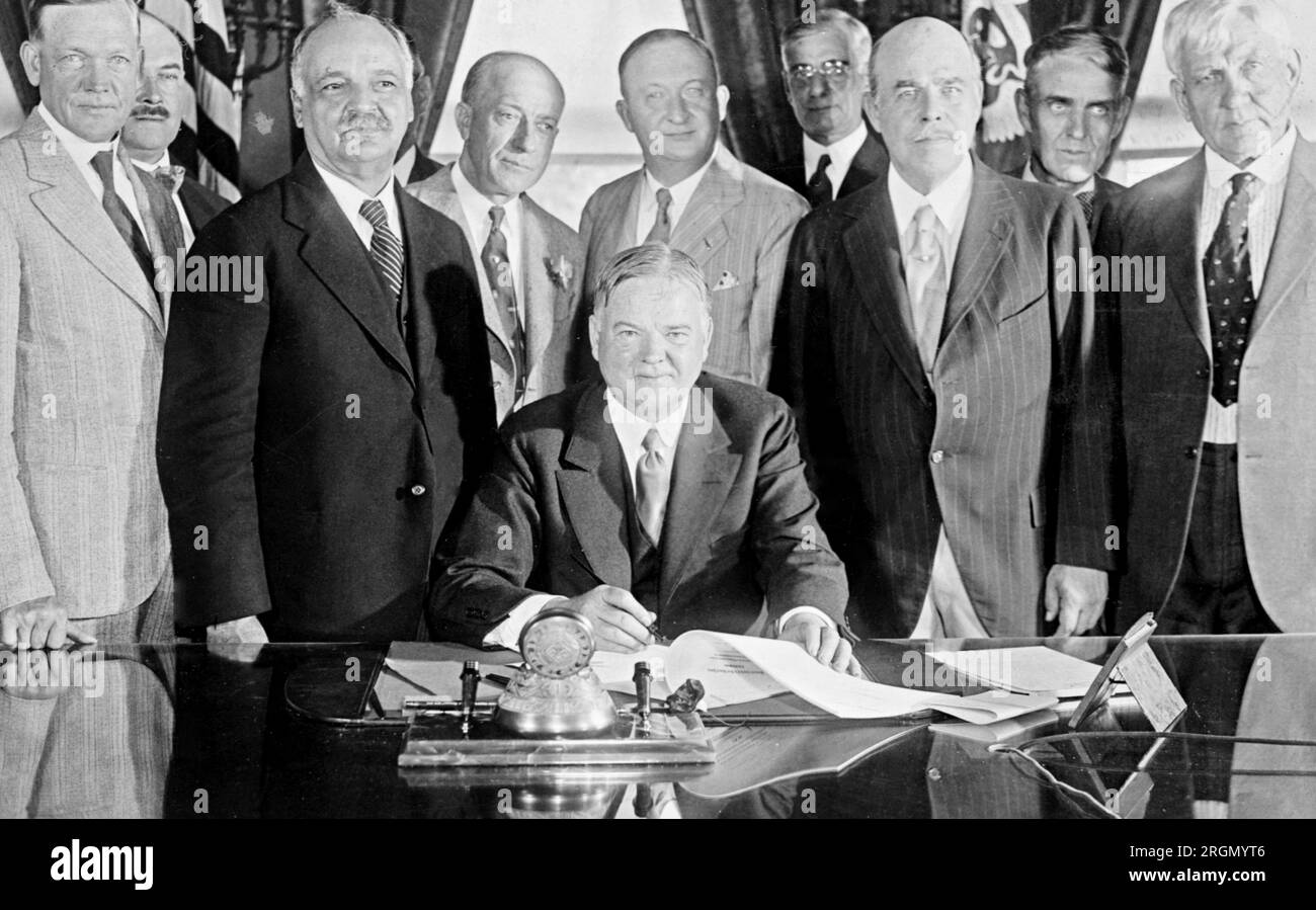 Herbert Hoover signing the Farm Relief Bill, with nine other men ...