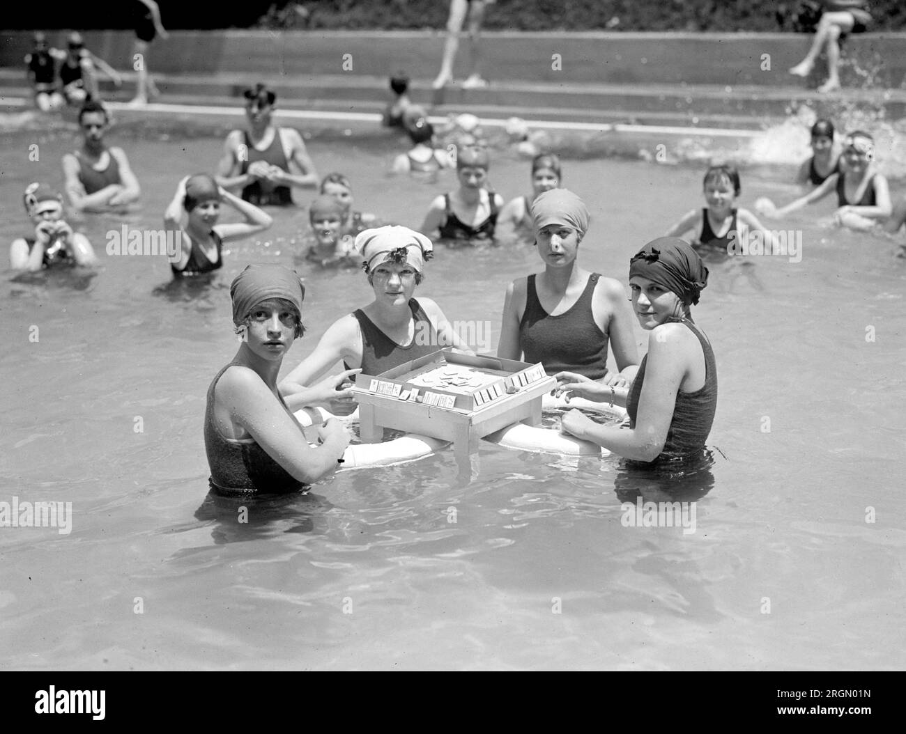 Four women playing Mah-Jong in a pool ca. 1924 Stock Photo - Alamy