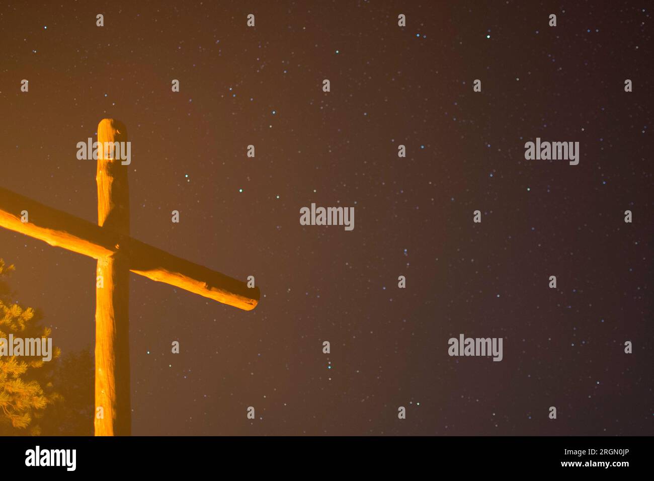 Cross on top of a mountain on a starry night Stock Photo - Alamy