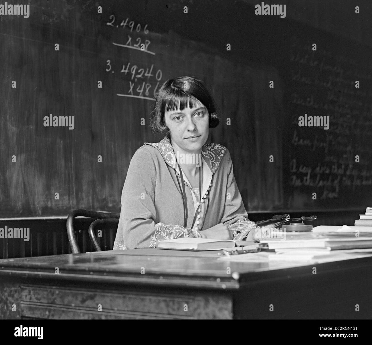 School teacher Miss Elizabeth Ramey sitting behind the desk in her ...
