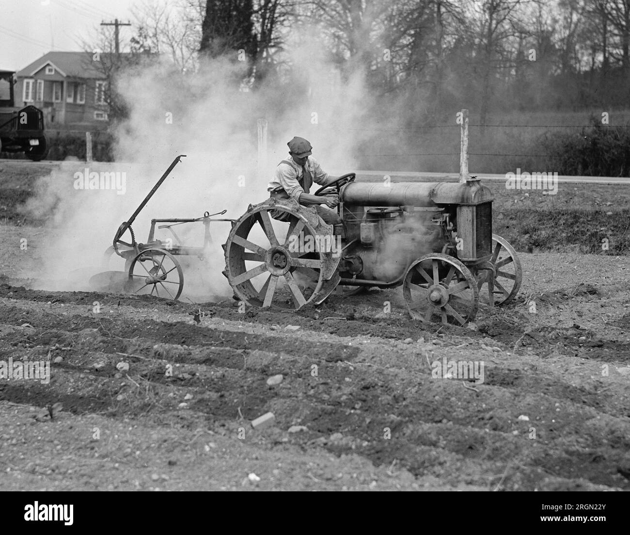 Farmer on a Ford tractor plowing a field ca. 1925 Stock Photo - Alamy
