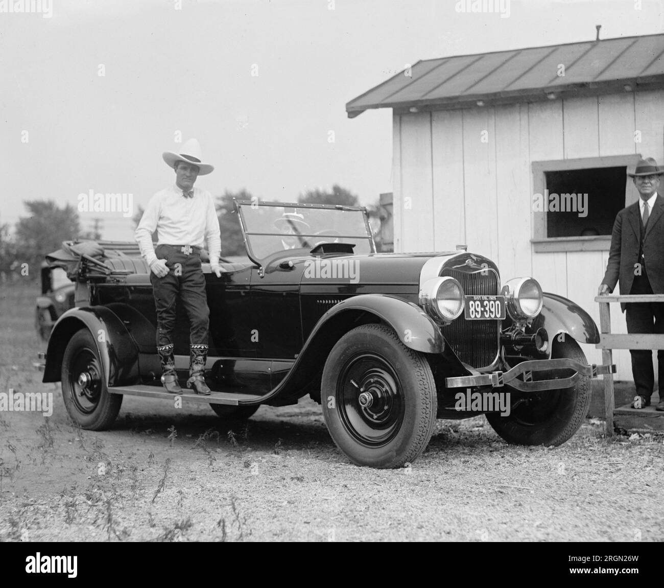 Cowboy actor Tom Mix standing on the running board of a Lincoln ...