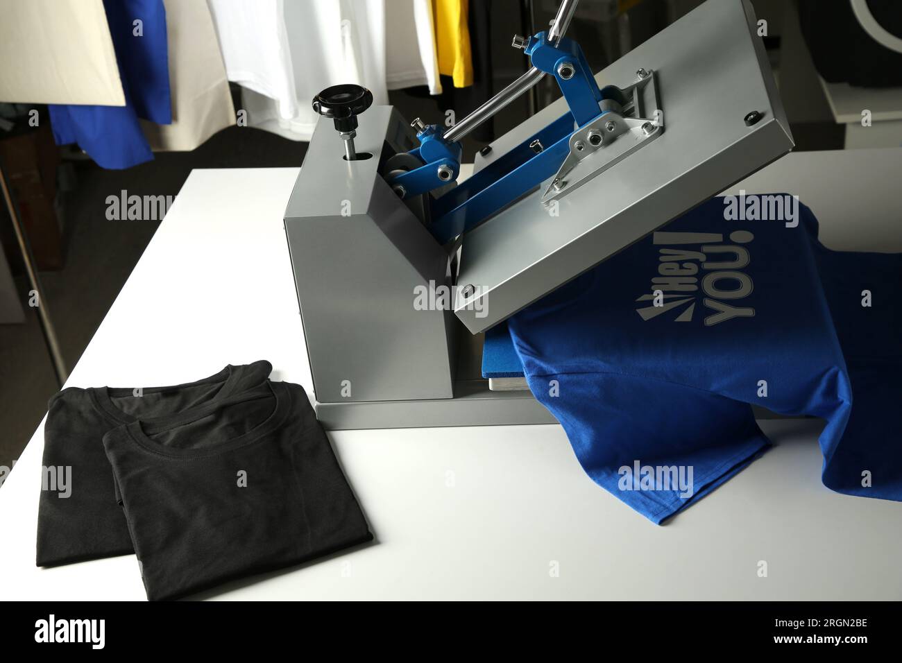Printing logo. Heat press with blue t-shirt on white table Stock Photo ...