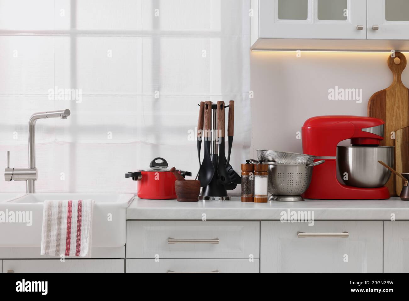 Set of different utensils on countertop in kitchen Stock Photo - Alamy
