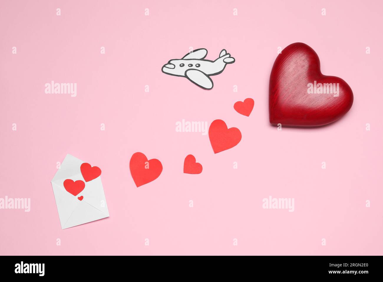 Long-distance relationship concept. Decorative hearts flying out of ...