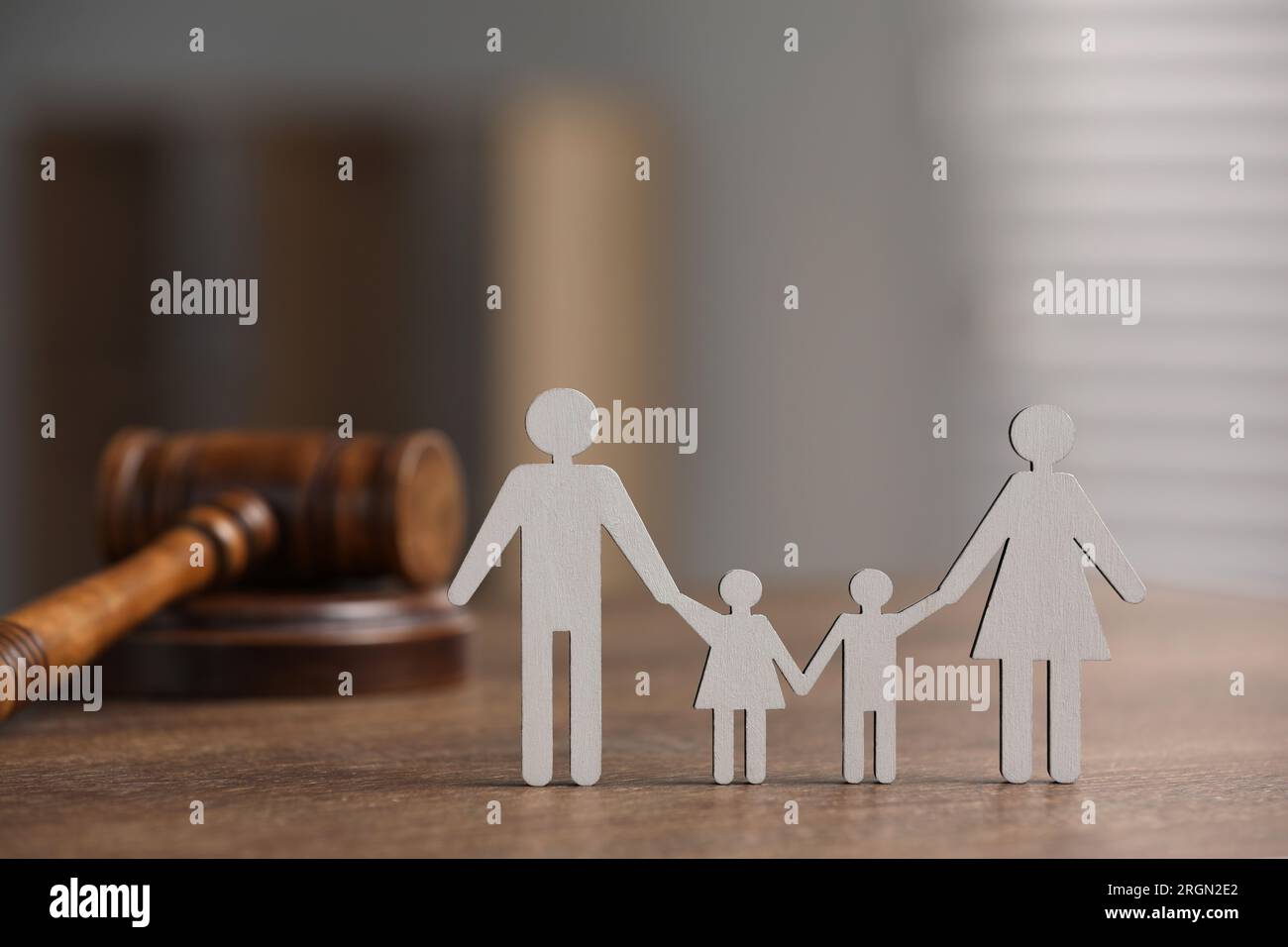 Family law. Figure of parents with children and gavel on wooden table ...