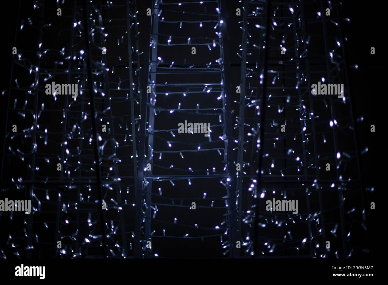 Texture from garlands. Led bulbs. White lights in dark. Glow on black ...