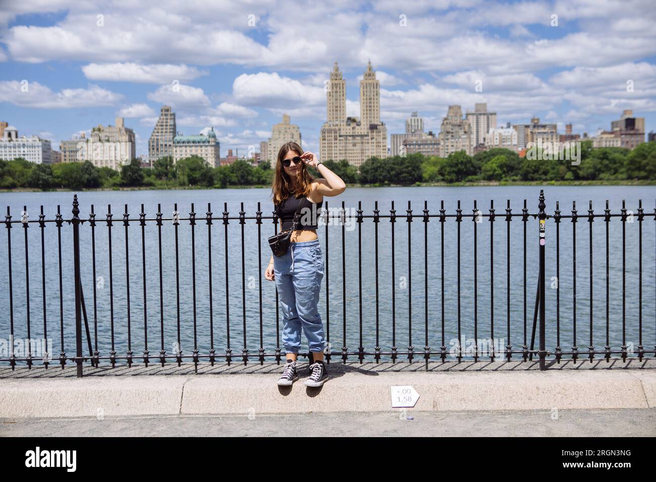 Teen girl posing by the Reservoir in Central Park, New York City, USA ...