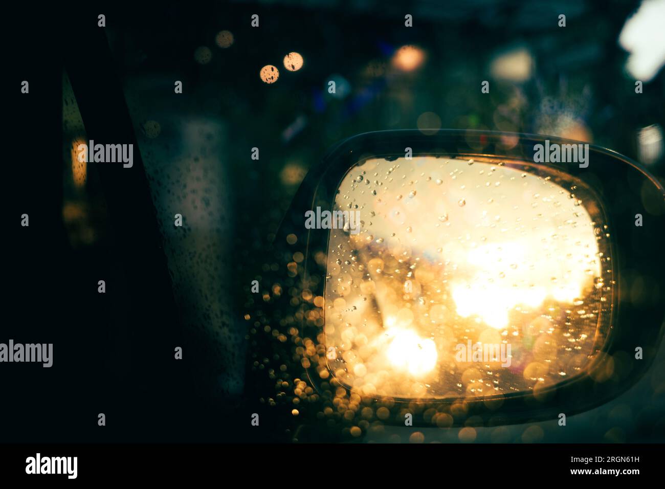 Moody scene of side mirror of car reflecting with sunlight after ...