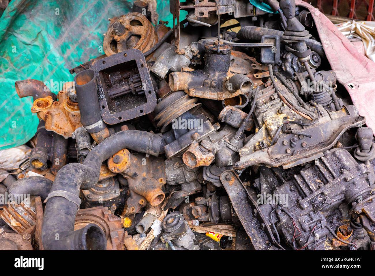 Pile of rusty and dirty obsoleted old vehicle metal engine and spare ...