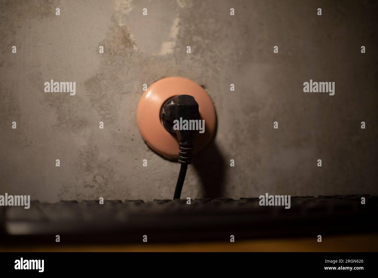 Plug in socket. Electricity at home. Black cable. Wires in apartment ...