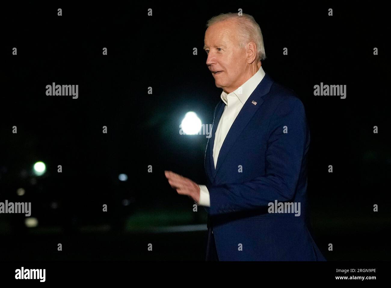 President Joe Biden walks across the South Lawn of the White House in ...