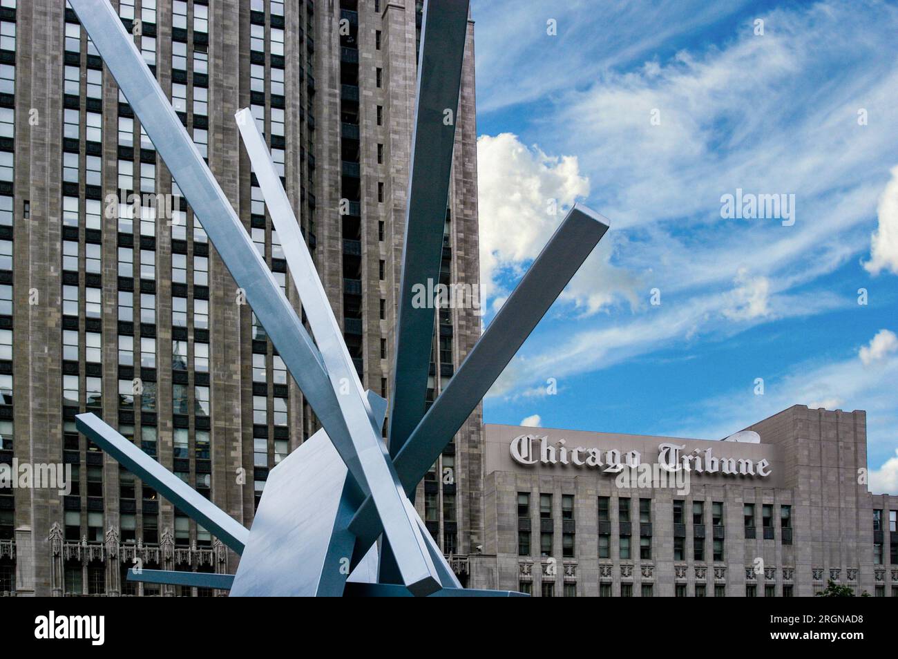 A piece of large piece of metal art is in font of the Chicago Tribune ...