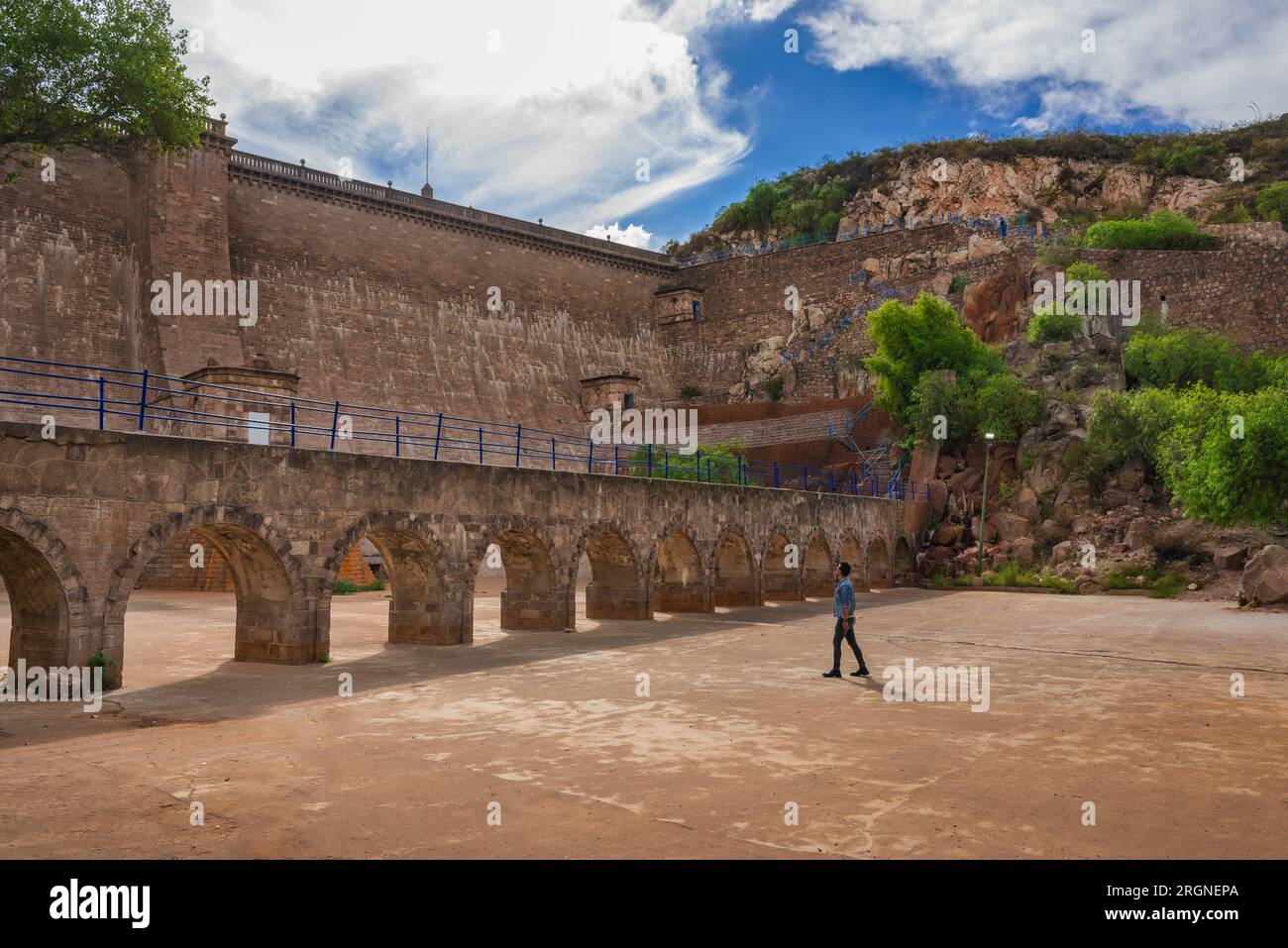 magnificent stone dam with an arched bridge during spring with blue sky ...