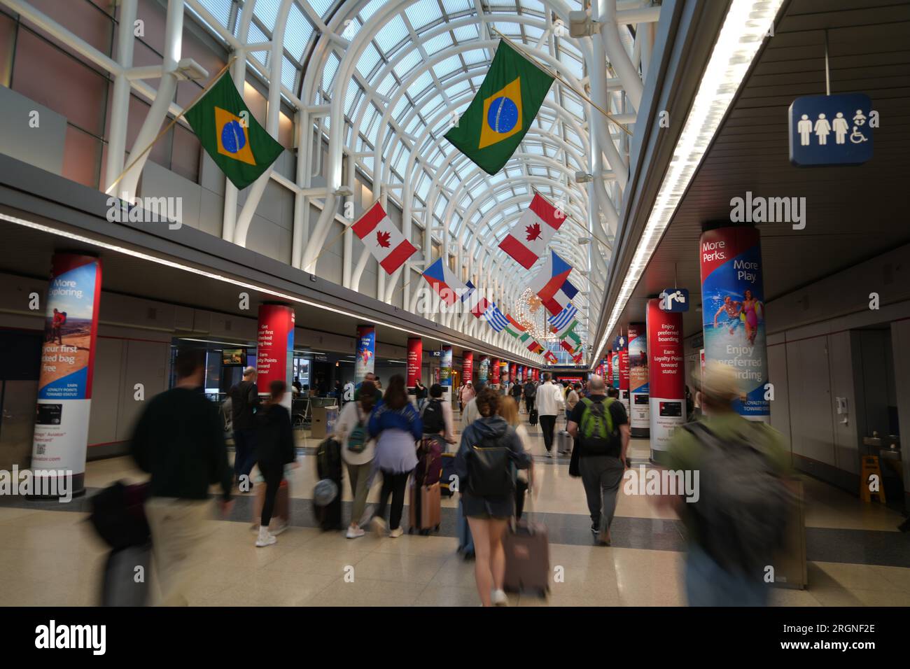 Passengers walk through Terminal 3 at O'Hare International Airport ...