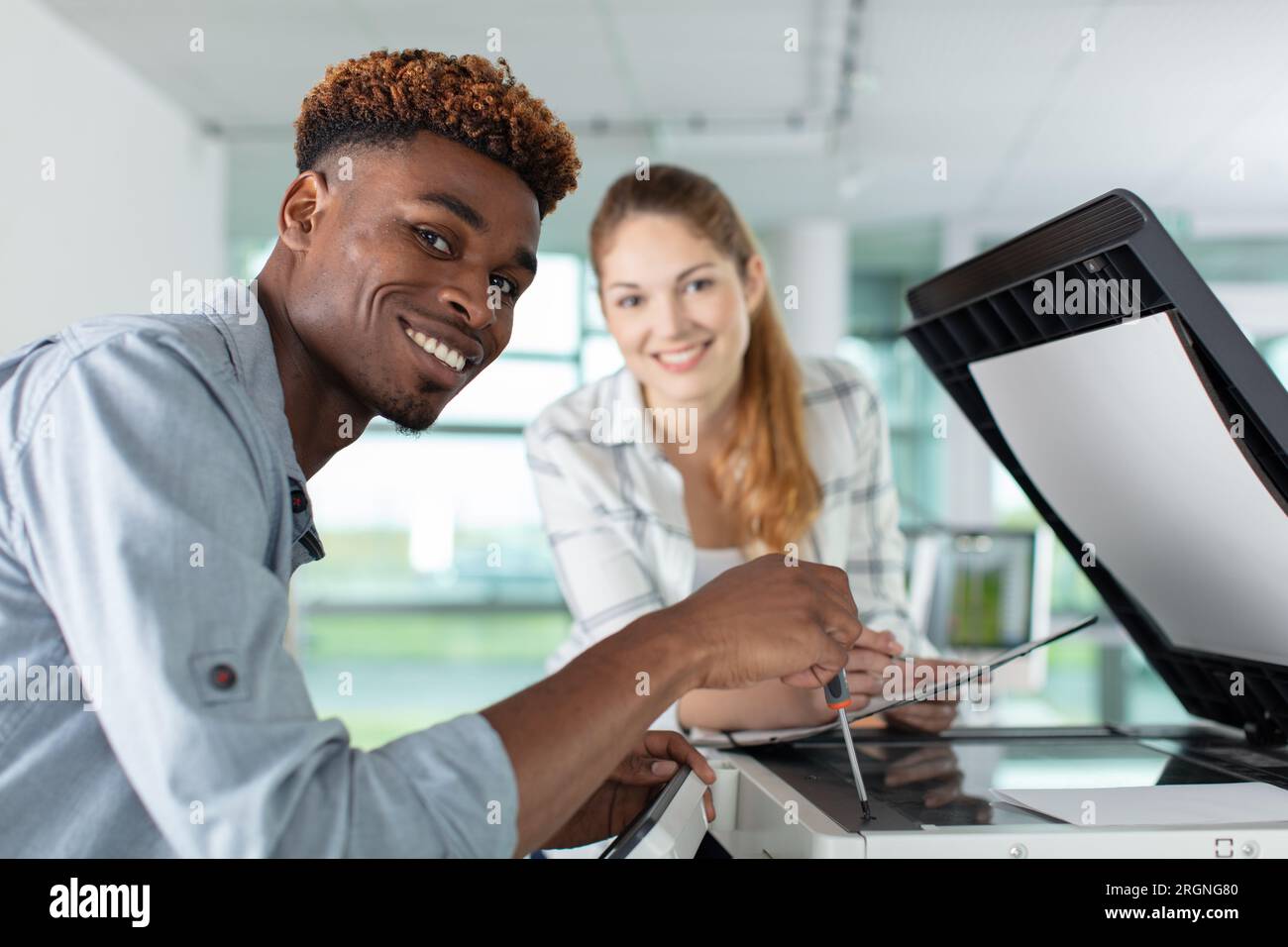 woman opening photocopy machine in office Stock Photo - Alamy