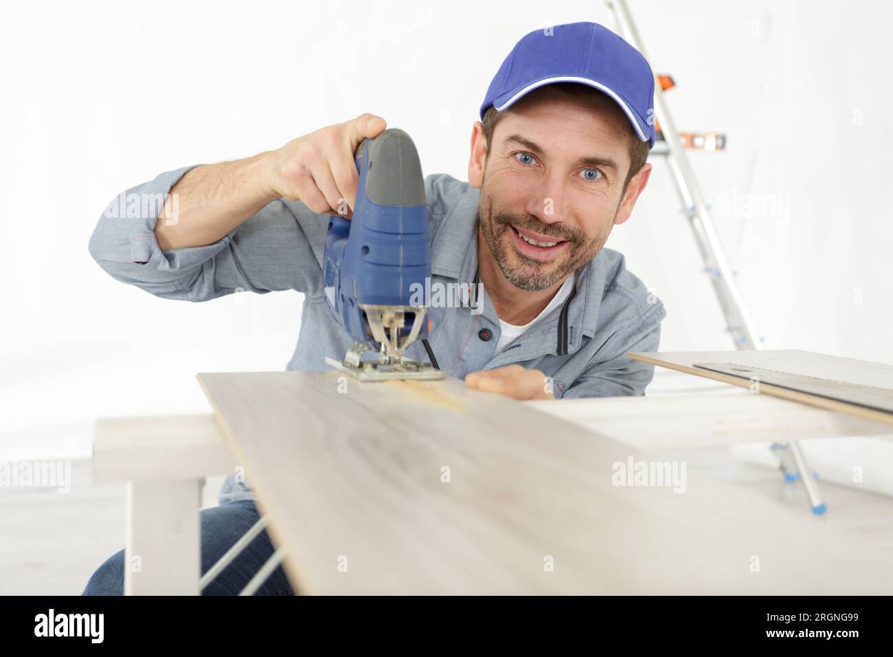carpenter measuring plank of wood Stock Photo - Alamy