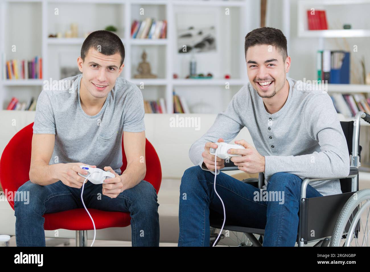happy young brothers playing video games one on wheelchair Stock Photo ...