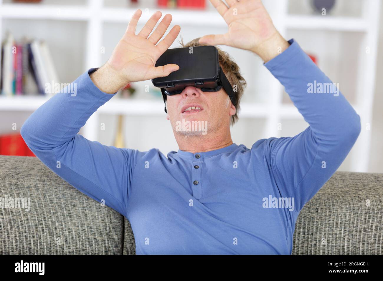 scared man taking off virtual reality headset Stock Photo - Alamy