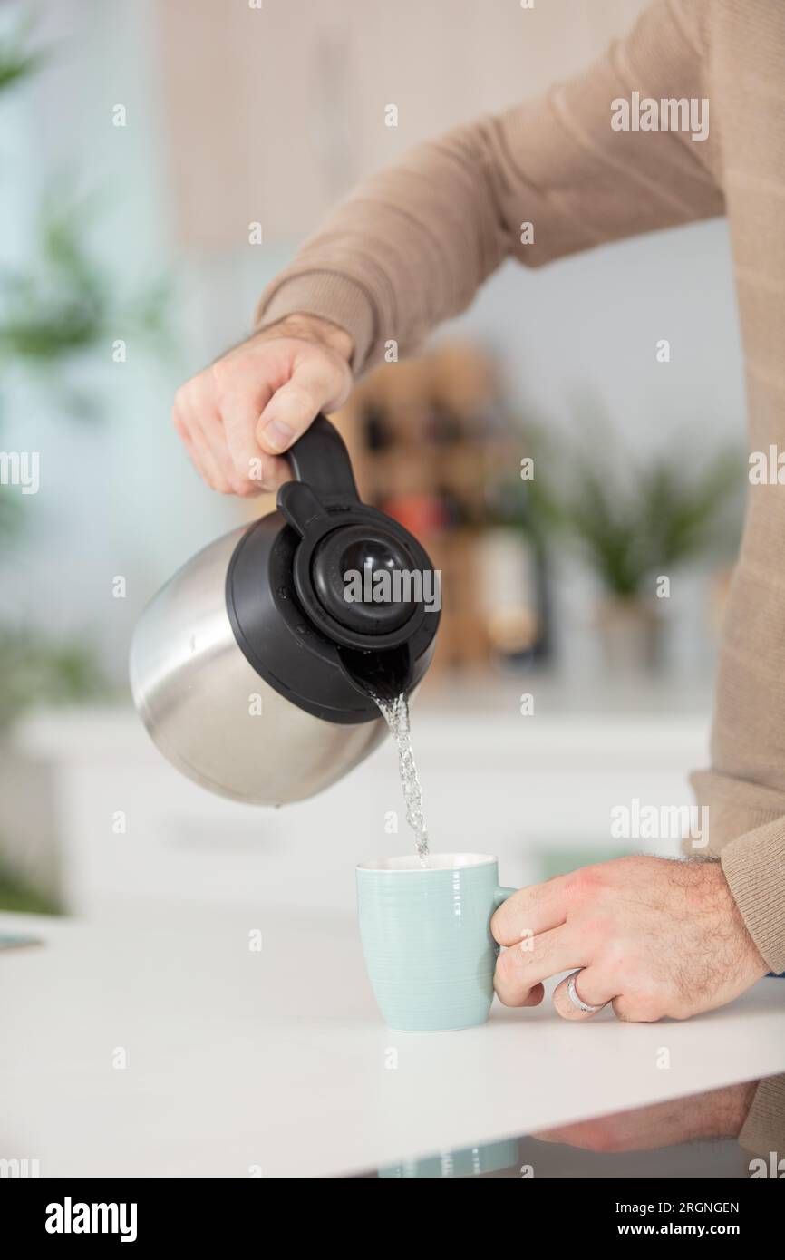 Man pours tea cup teapot hi-res stock photography and images - Alamy