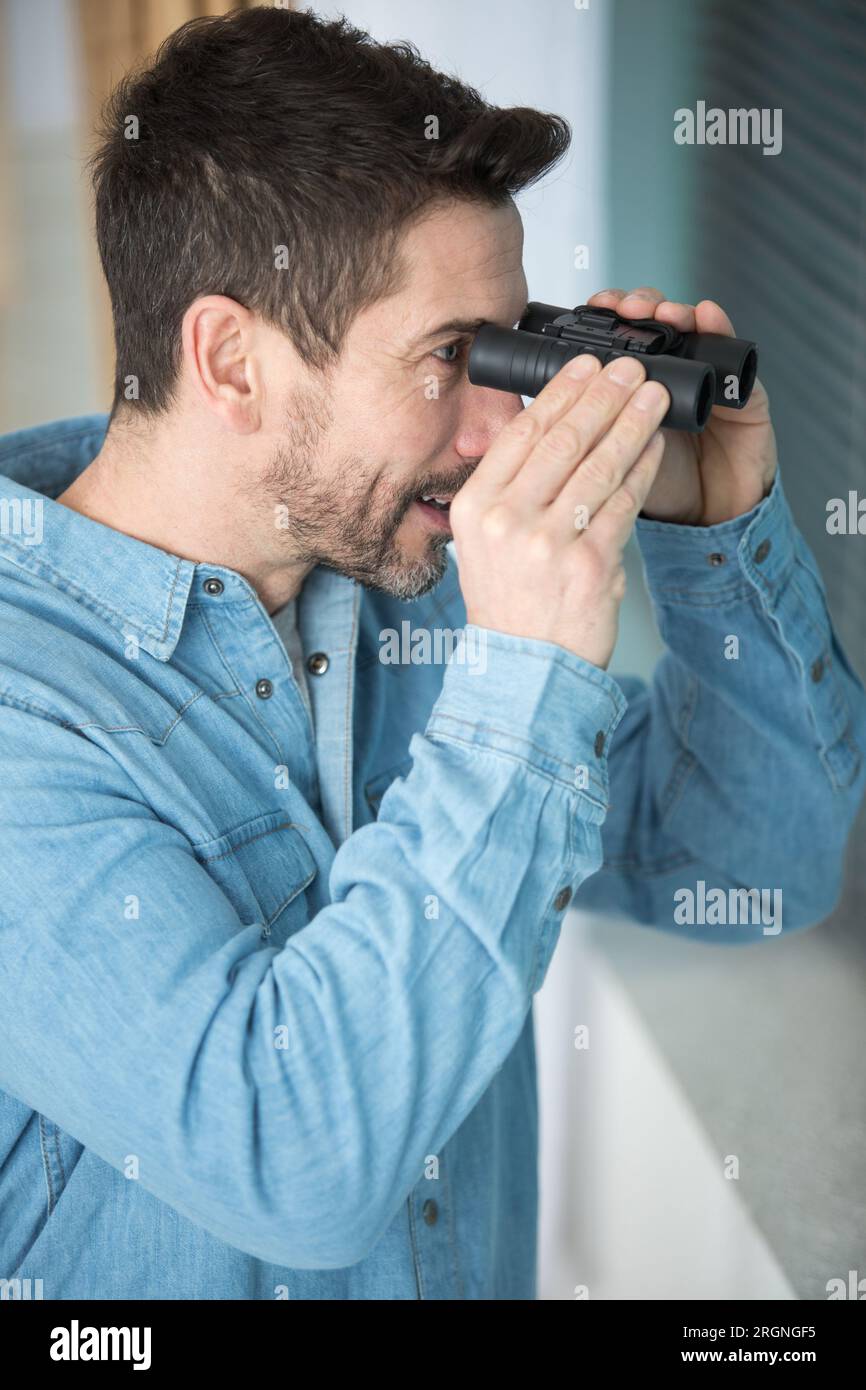 Binoculars looking through window hi-res stock photography and images ...