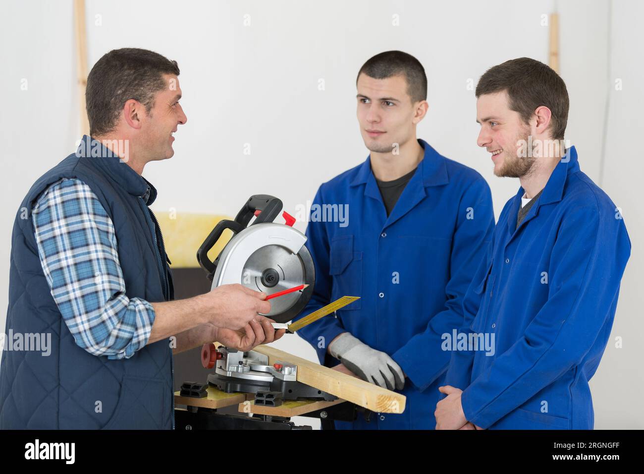 apprentices in front a circular saw Stock Photo - Alamy