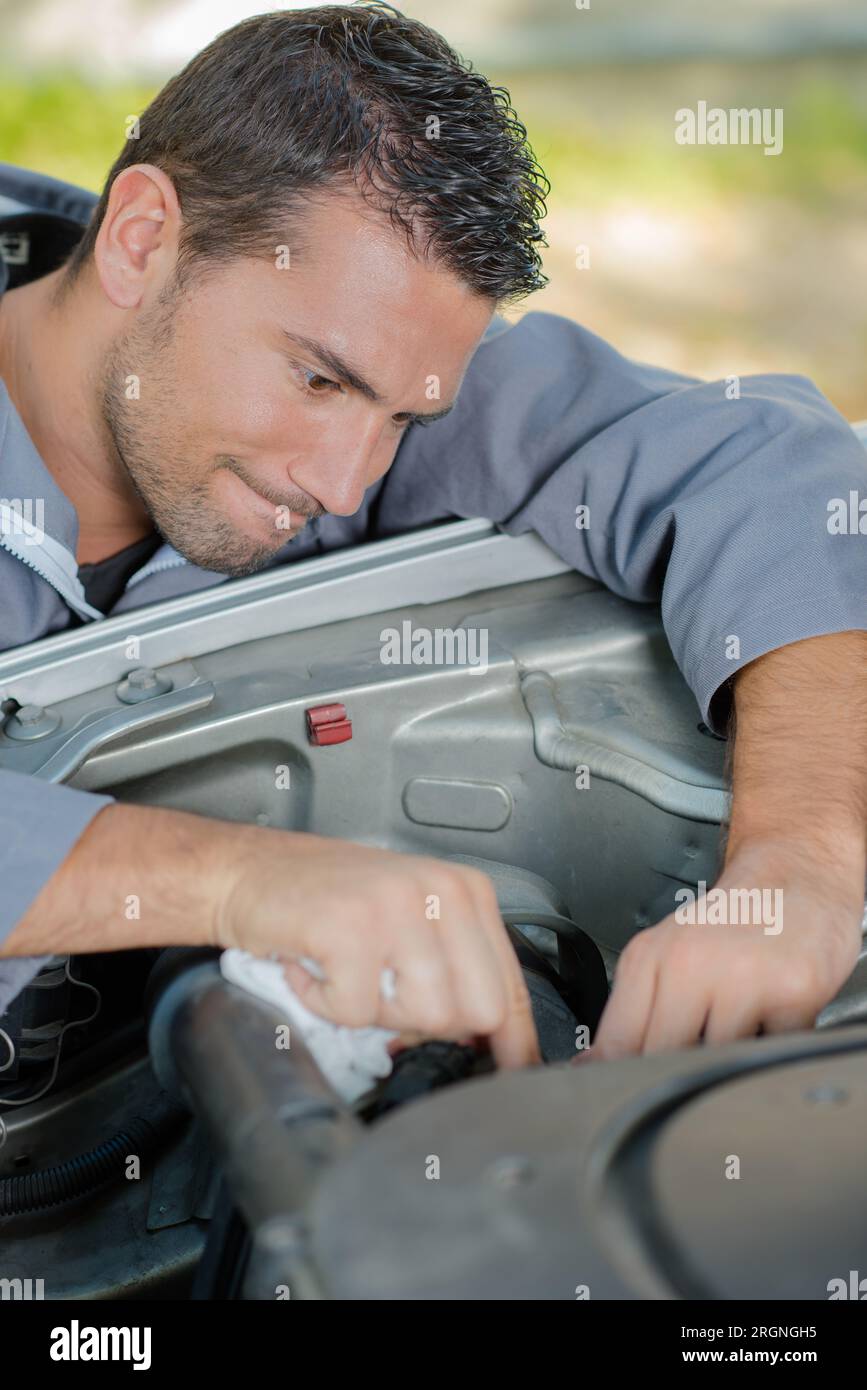 mechanic is working outdoors with a car Stock Photo - Alamy