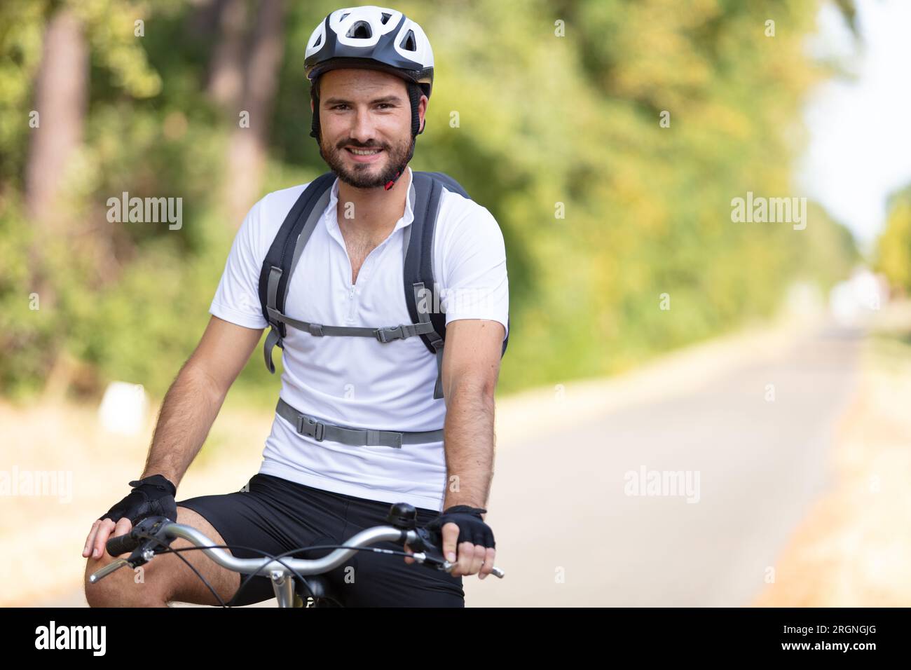 cyclist riding a bike on a road Stock Photo - Alamy