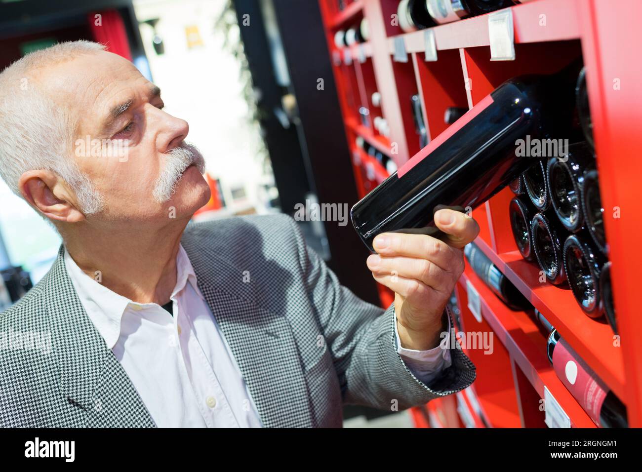 taking wine bottle out of the shelf Stock Photo - Alamy