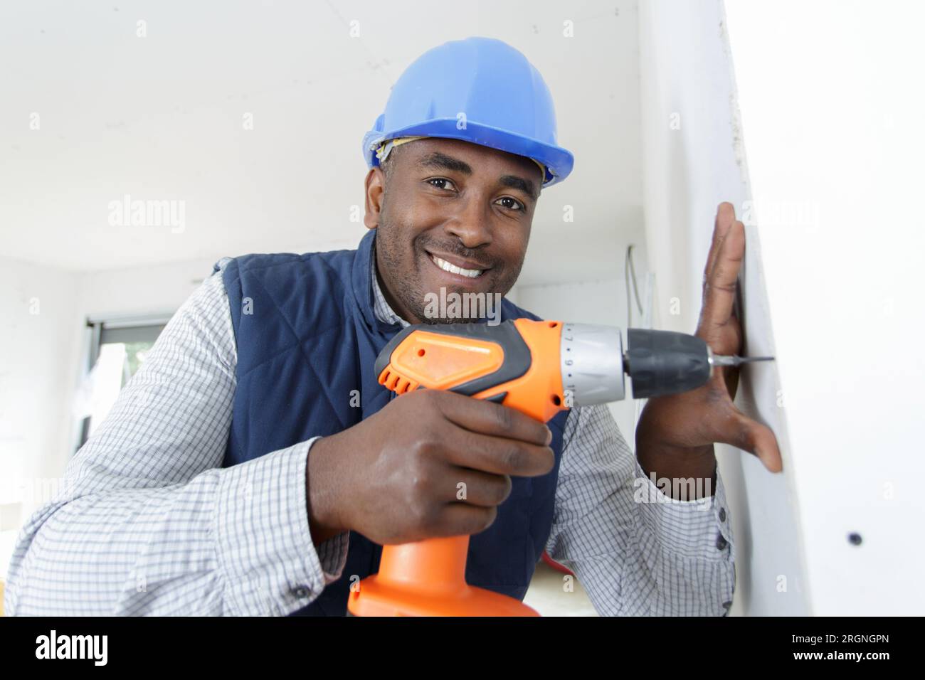 Happy man drills wall hi-res stock photography and images - Alamy