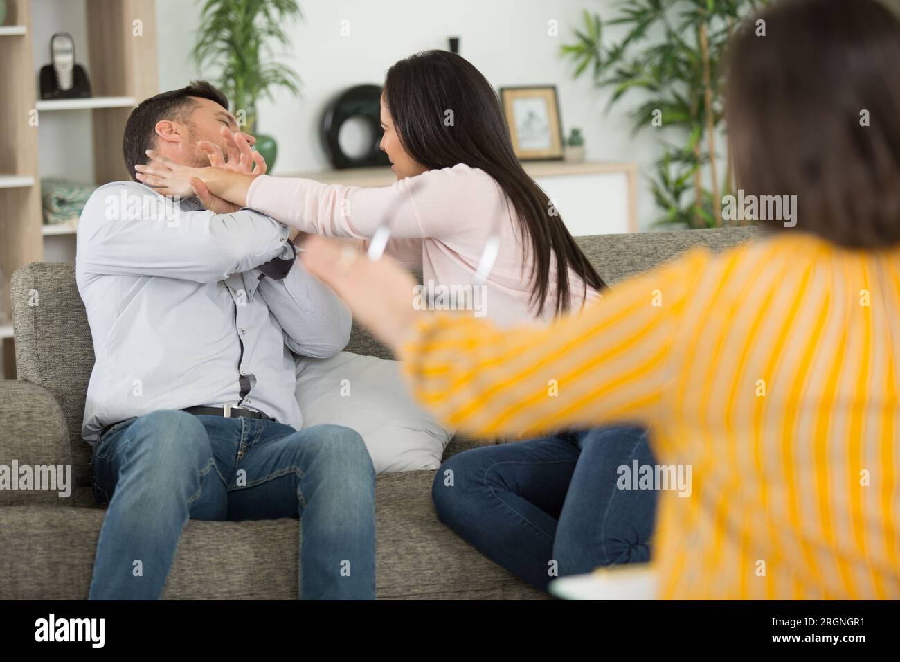 woman being violant to her husband during therapy session Stock Photo ...