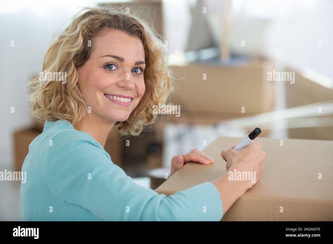 beautiful young woman opening box Stock Photo - Alamy