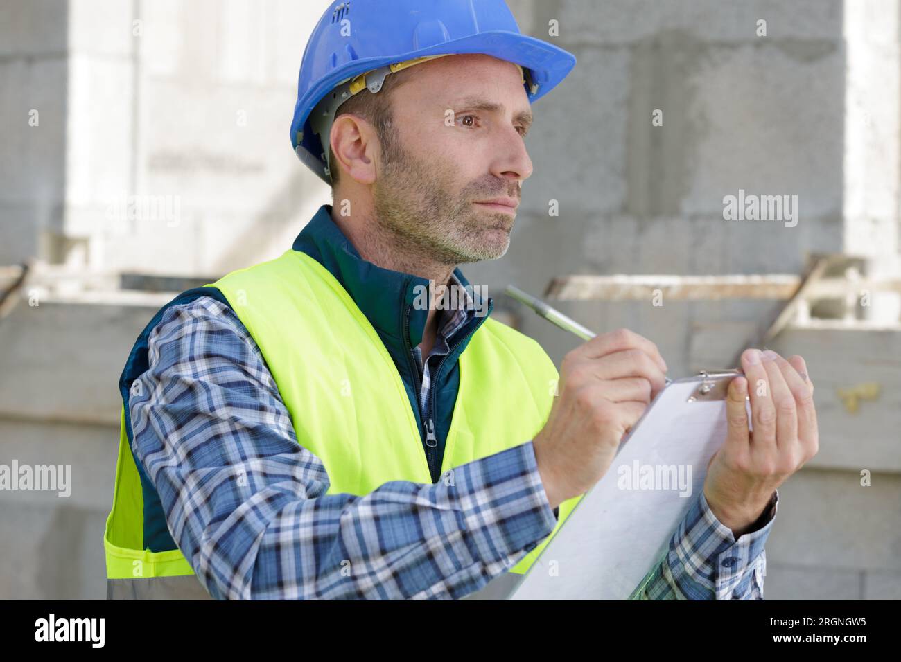 Engineer outdoors checking clipboard hi-res stock photography and ...