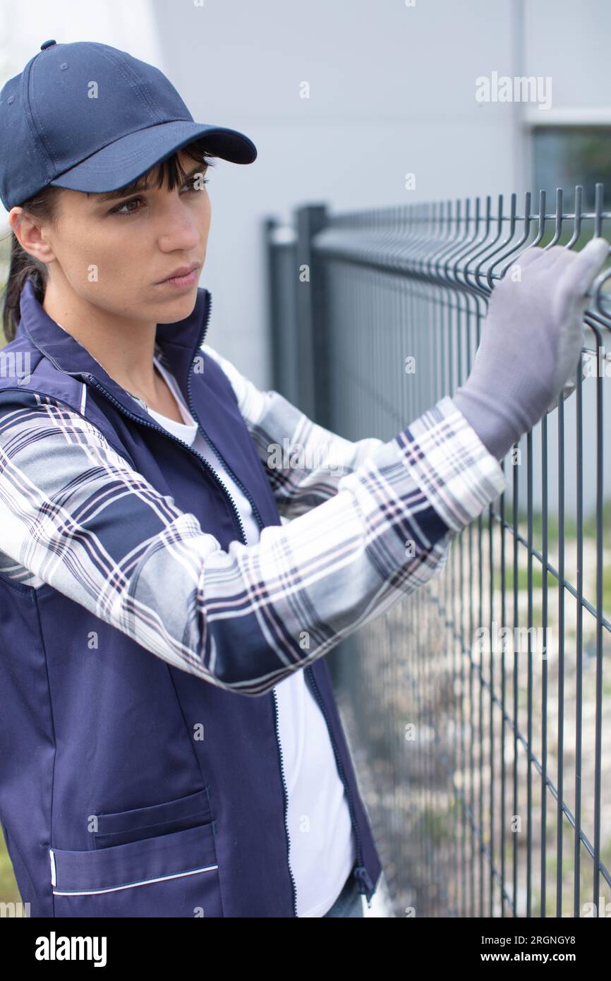 woman worker installing welded metal mesh fence Stock Photo - Alamy