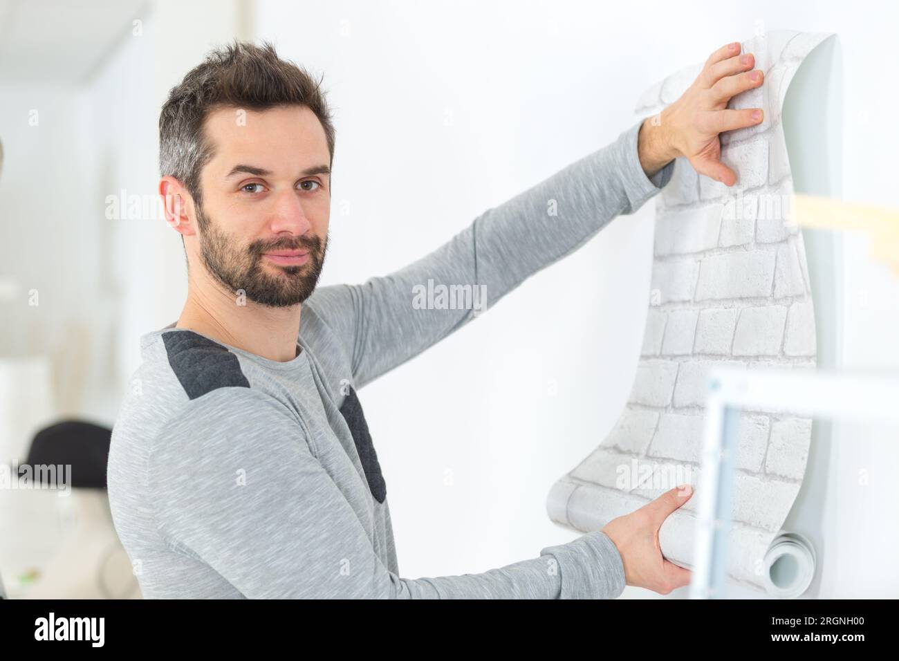 Putting wall paper hi-res stock photography and images - Alamy