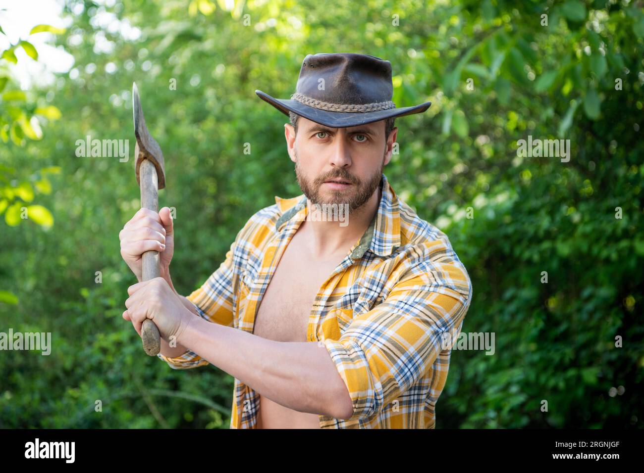 cowboy threaten with axe outdoor. photo of cowboy with axe. cowboy with ...