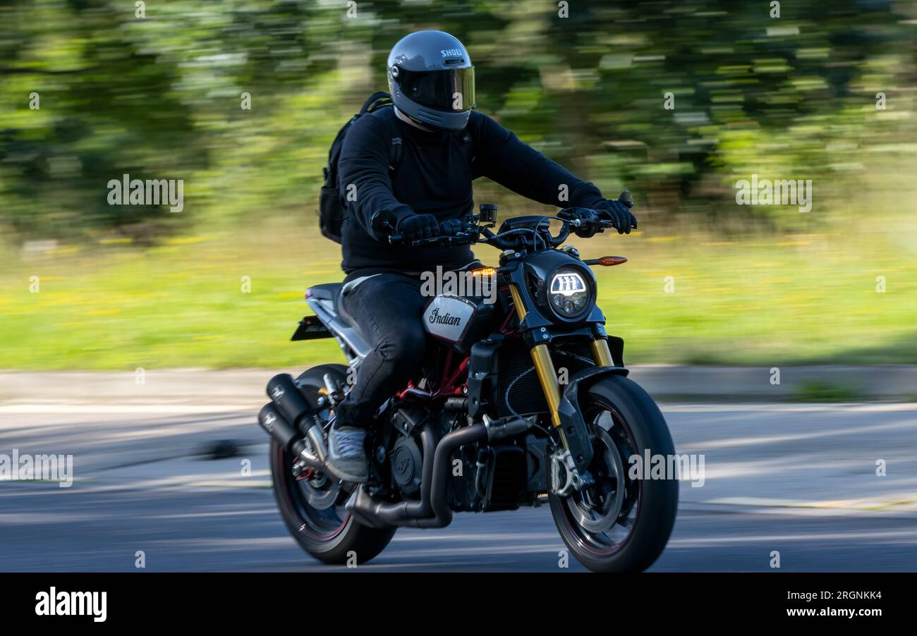 Milton Ketnes,UK - Aug 10th 2023: Man riding an Indian motorcycle on an ... Milton Ketnes,UK - Aug 10th 2023: Man riding an Indian motorcycle on an ...
